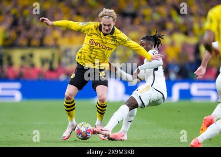 Real Madrid's Eduardo Camavinga, left, vies for the ball with Barcelona ...