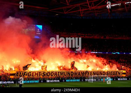 Borussia Dortmund fans let off smoke flares in the stands during the ...