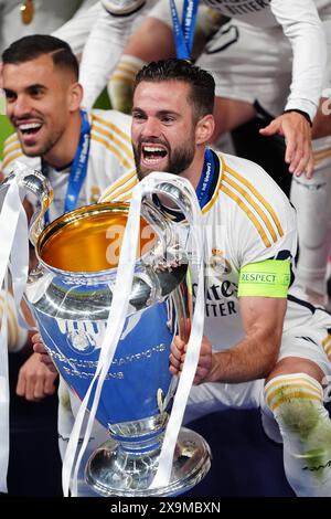 Real Madrid's Nacho Fernandez lifts the trophy as he celebrates winning ...