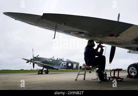 A engineer works to prepare a Spitfire outside the Heritage Hangar at ...