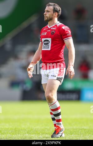 Joe Mellor of Salford Red Devils is tackled during the Betfred Super ...