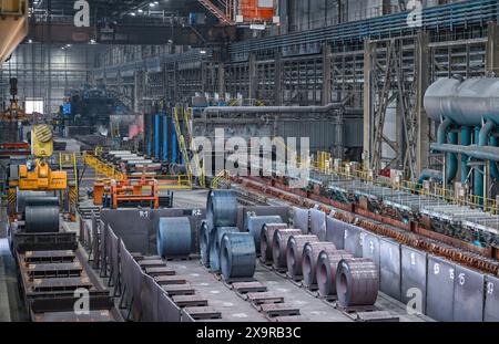 30 May 2024, Brandenburg, Eisenhüttenstadt: Steel slabs lie in a ...