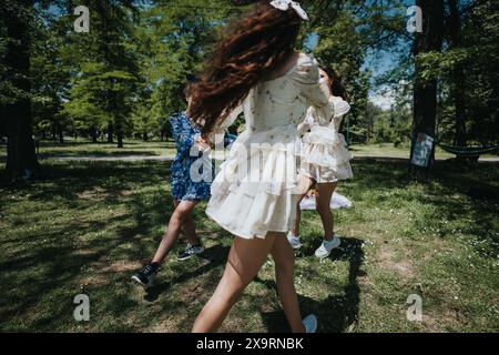Joyful sisters dancing in a circle in a sunny park, embodying happiness ...