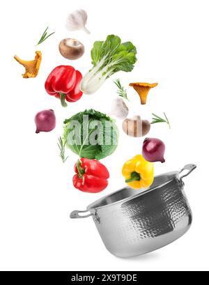 Fresh ingredients falling into saucepan on white background Stock Photo ...