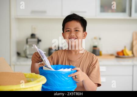 smiling boy sorting paper waste Stock Photo - Alamy