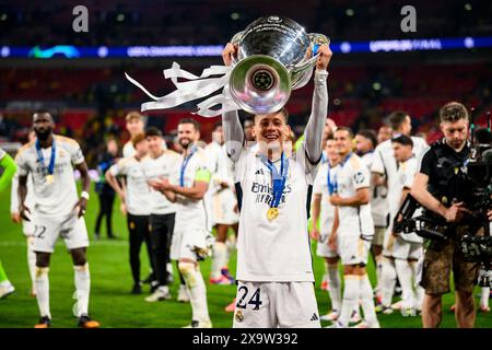 Real Madrid's Arda Guler celebrates with the trophy after winning the ...