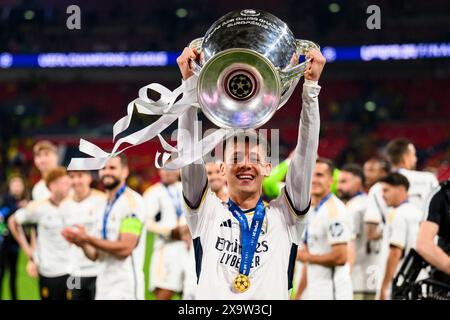 Real Madrid's Arda Guler celebrates with the trophy after winning the ...