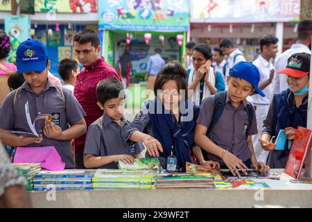 Children crowd at a stall at Amar Ekushey Book Fair at Suhrawardi Udyan ...
