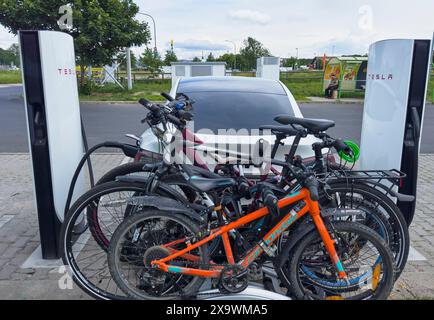 Tesla electric car with bike rack on the trailer hitch at a Tesla Super ...