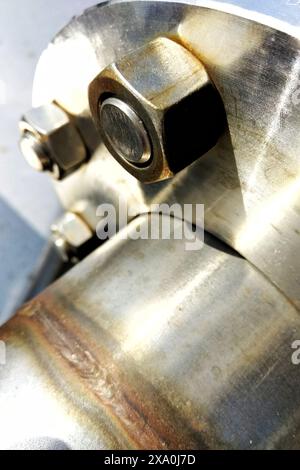 A close-up of sealed metal pipe outlets installed in a brick wall ...
