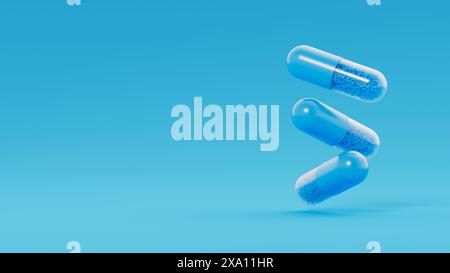 Three blue transparent capsules, pills with blue granules inside lay on ...