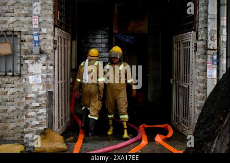 NOIDA, INDIA - JUNE 3: Fire brigade personnel extinguish the fire at a ...