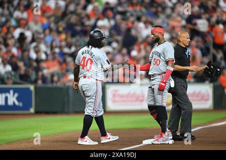 Minnesota Twins third base coach Tommy Watkins, left, congratulates ...