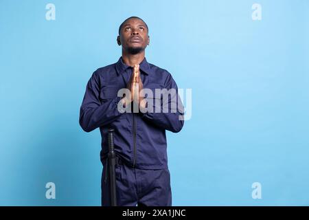 African American adult talking to Jesus Christ by saying grace ...