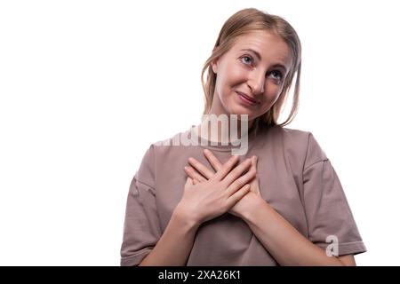 Blonde adult woman cutely crossing her hands over her heart Stock Photo ...