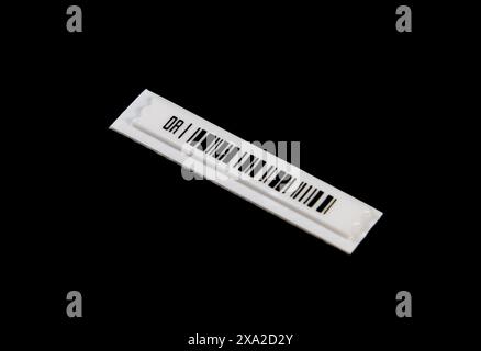 Anti-theft magnetic barcode label on black backdrop Stock Photo - Alamy