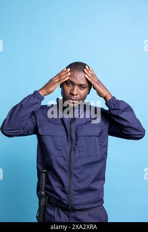 African american patrol officer is feeling tired and unwell from a ...