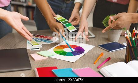 Group of designers choosing color samples together at the table Stock ...