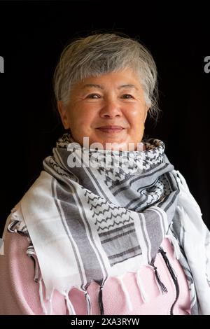 An elderly Eurasian Chinese/Italian woman wearing a keffiyeh to ...