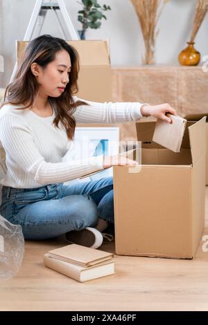 Young woman with cardboard box on blue background Stock Photo - Alamy