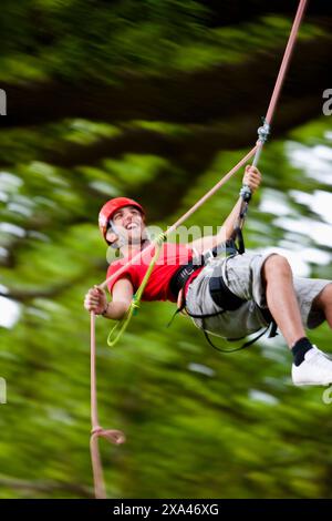 Man dangling from a rope suspended mid air Stock Photo - Alamy