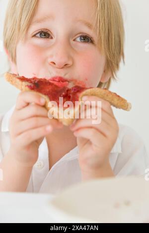 Boy Eating Jam on Toast Stock Photo - Alamy