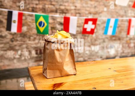 Potato chips on a wooden surface in a saucer Stock Photo - Alamy