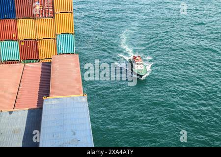 Cargo Ship loaded with containers moving through water Stock Photo - Alamy
