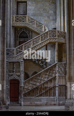 Elegant spiral staircase with intricate railing and chandelier Stock Photo - Alamy