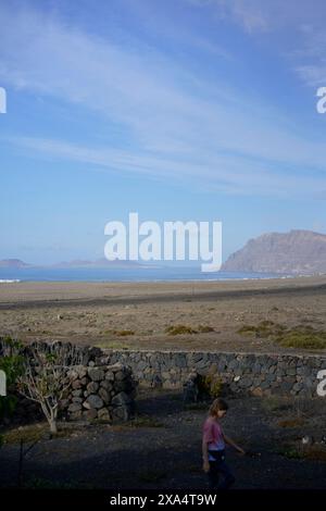 A scenic view of a volcanic mountain under blue sky covered with white ...