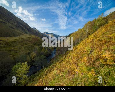 A scenic view of a mountain range partly covered with snow under a ...