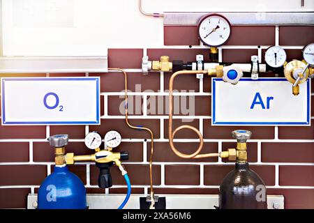Oxygen and argon cylinders and piping with pressure gauges Stock Photo ...
