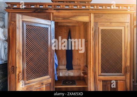 Grid of a confessional in a Christian church, with the symbol of the ...