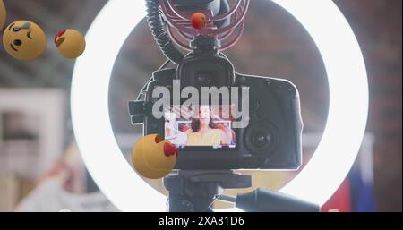 Image of emoji icons over female culinary vlogger recording vlog at ...