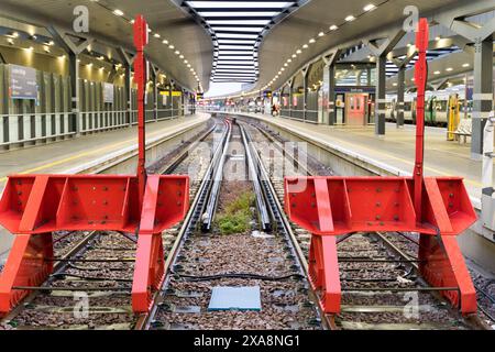 two train buffer stops in red installed at the end of platform with ...