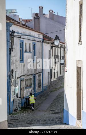 Cobblestone street in the Town of Sines, Setubal, Portugal that is also ...