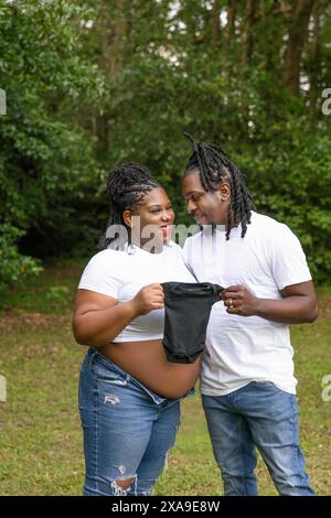 African American mother holding young son, both smiling and interacting ...