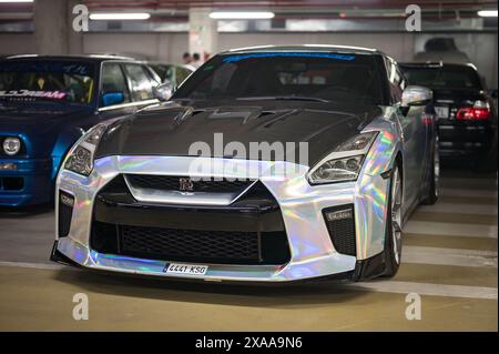 Front view of a black Nissan GT-R35 with a carbon fiber body kit at a ...