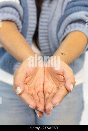 Hand extended open in a welcoming gesture against a clean white ...