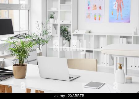 Massage therapist's workplace with laptop in medical office Stock Photo ...