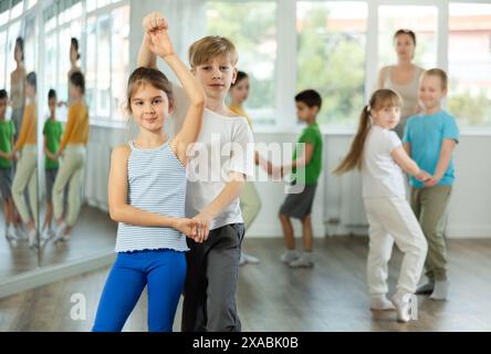 Girl paired up with boy and training to perform slow couple dance ...