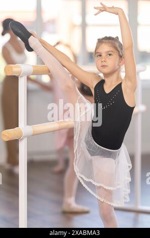 Ballet pose grand batman - little girls at a choreography lesson are ...