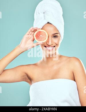 happy girl in towel with grapefruit on yellow background Stock Photo ...