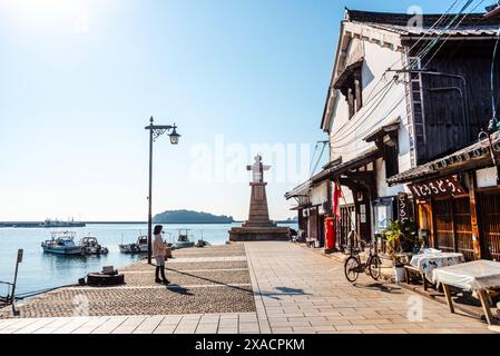 Iconic stone lighthouse at the port of the traditional fishing village ...
