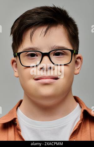 Portrait of cheerful autism boy with glasses in blue shirt front a ...