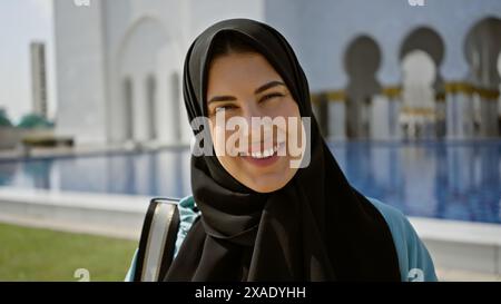 Beautiful hispanic woman wearing islamic hijab holding japanese yen ...