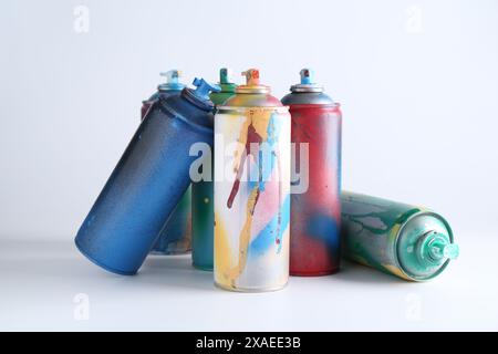 Many spray paint cans on pink background Stock Photo - Alamy