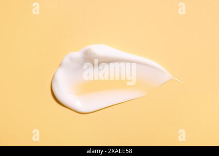 Sample of face cream on pale yellow background, top view Stock Photo ...