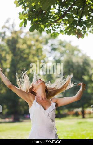 A young happy woman throws up a bunch of pieces of paper and documents ...