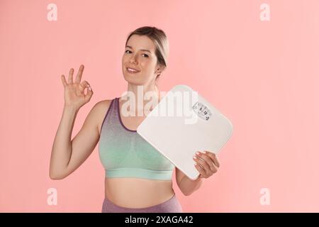 Beautiful woman with scales showing OK gesture on pink background Stock ...